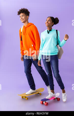 Photo of joyous african american couple wearing colorful sweatshirts ...