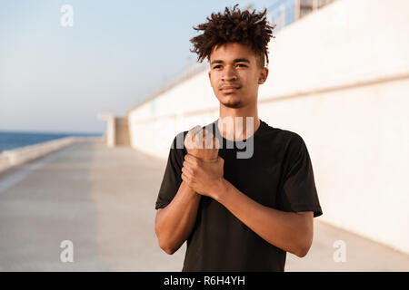 Image of handsome young guy sportsman standing with skipping rope ...