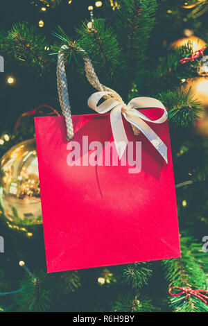 Red gift box hanging on christmas tree Stock Photo - Alamy