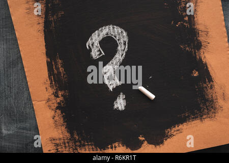 Sketched question mark on cardboard paper, concept of perplex and ...