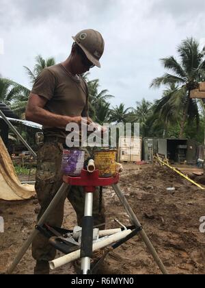 US Navy Utilitiesman Constructionman Matthew Glover loads a chalk ...