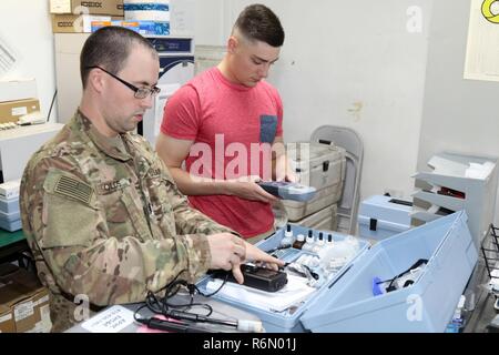 Civilians and U.S. Army soldiers review the functions of a Harbormaster ...
