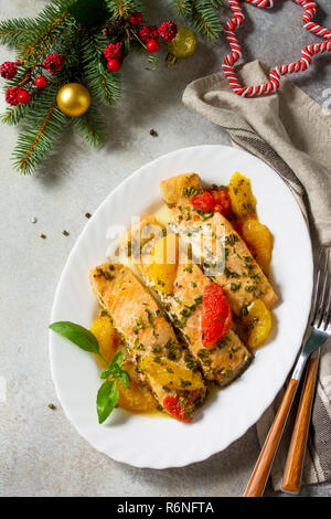 Grilled salmon fish fillet with salt, pepper and rosemary over salad ...