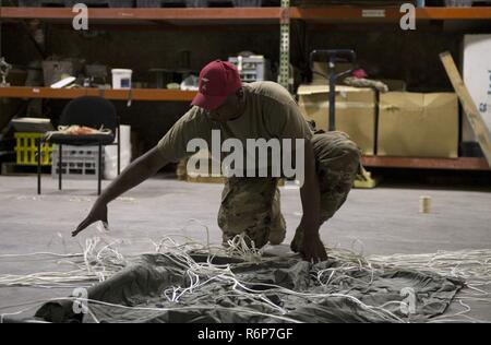 A U.S. Army Joint Airdrop Inspection rigger with the 421st ...