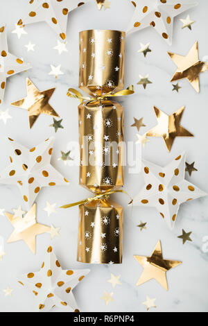 Christmas crackers with shiny confetti on color background, top view ...
