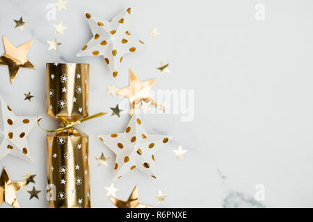 Christmas crackers with shiny confetti on color background, top view ...