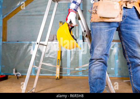 Attic construction and renovation tools, yellow safety helmet, gloves ...