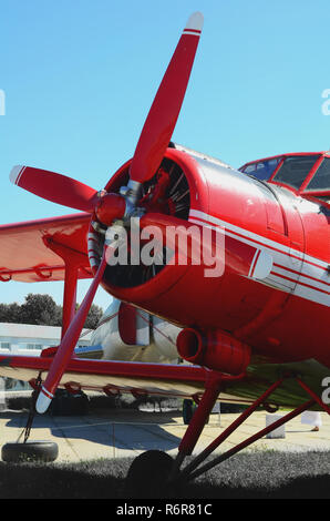 Front part of a red aircraft with a propeller. Screws, texture, surface ...