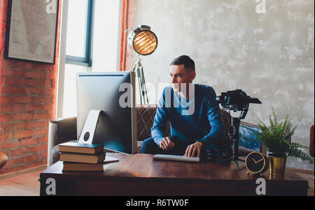 stabilizer camera. computer monitor. Young freelancer man editing video ...