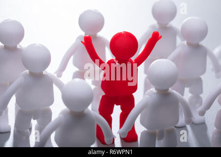 Red Human Figure Surrounded By Team Representing Unity Stock Photo - Alamy