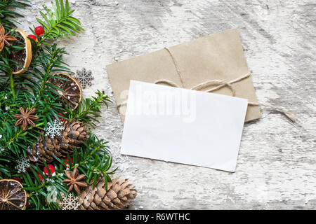 Envelope with fir tree branch and spices on grunge background. Hello ...