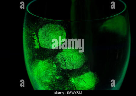 Thumb print fingerprints on wine glass showing up under blacklight ...