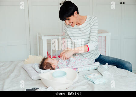 Mother changing a baby's nappy Stock Photo - Alamy