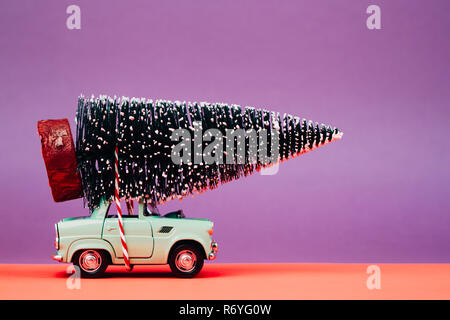 KYIV, UKRAINE - December 12, 2017: Toy red car with fir tree on the ...