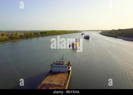 A cargo barge floats along the river. Cargo ship River port cargo ...