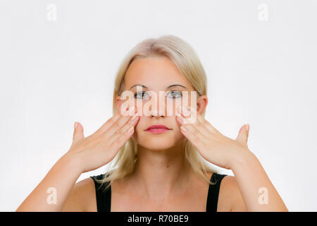 Face exercise cheekbone push up, female face with hands pulling the ...