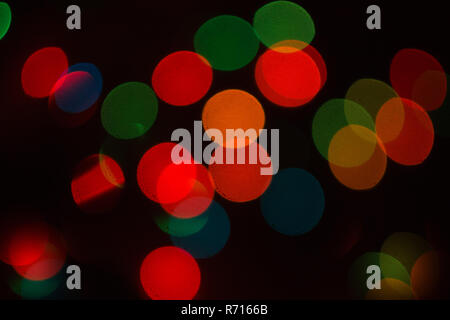 The festive garland glows with blurred bokeh and a flowerpot with a ...