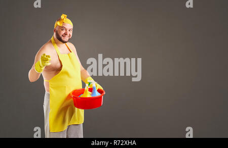 Funny fat cleaning man in an apron Stock Photo - Alamy