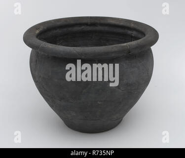 Black storage jar on standing surface, folded top edge above ...