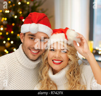 Happy couple in Santa hats drinking champagne on dark background with ...