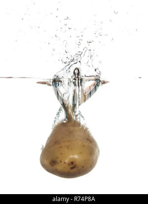 Potato splashing and sinking underwater. White beackgroung Stock Photo ...