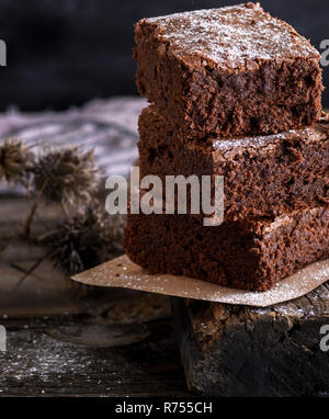 stack of square brownie pie slices covered with a thin layer of ...