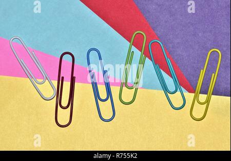 Multi colored paper clips scattered against blue background Stock Photo ...