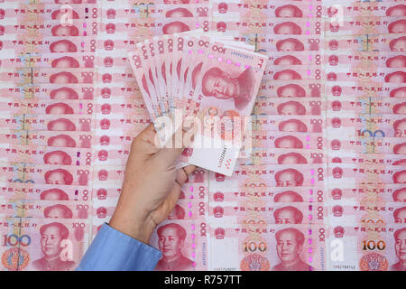 Hand holding Chinese Renminbi. RMB. Currency of China Stock Photo - Alamy