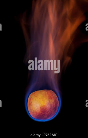 Peach on fire with blue flames isolated on black background Stock Photo ...