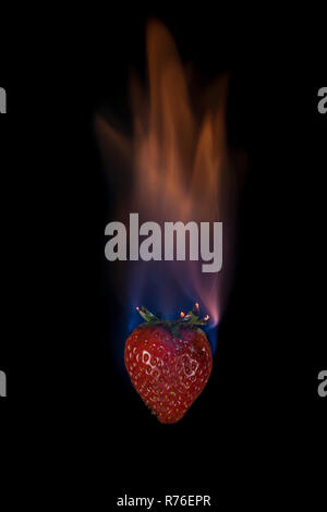 Strawberry on fire with blue flames isolated on black background Stock ...