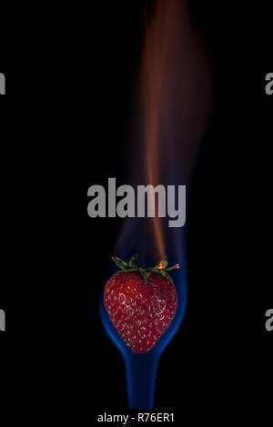 Strawberry on fire with blue flames isolated on black background Stock ...