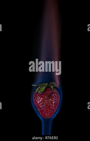 Strawberry on fire with blue flames isolated on black background Stock ...