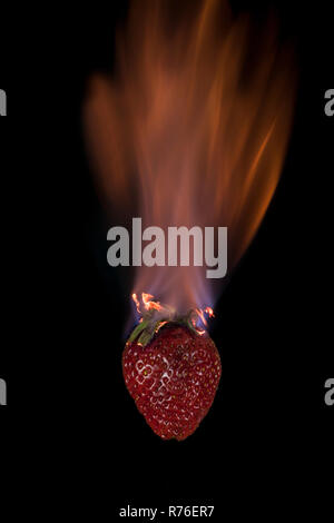 Strawberry on fire with blue flames isolated on black background Stock ...