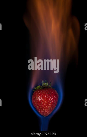 Strawberry on fire with blue flames isolated on black background Stock ...