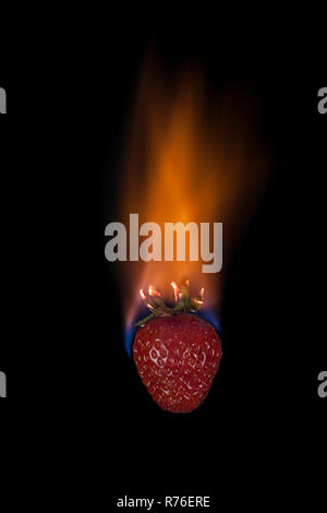Strawberry on fire with blue flames isolated on black background Stock ...