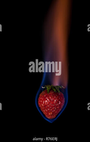 Strawberry on fire with blue flames isolated on black background Stock ...