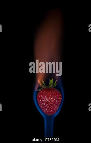 Strawberry on fire with blue flames isolated on black background Stock ...