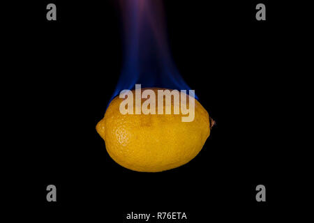 Lemon ot fire with blue flames isolated on black background Stock Photo ...