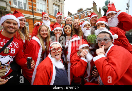 Participants in Santa costumes meet in Brixton, south London, before ...