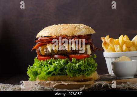 Homemade bacon burger with lettuce and cheddar, homemade potato french ...