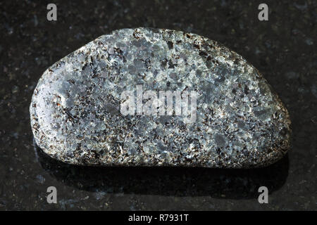 tumbled Peridotite stone with Phlogopite on black Stock Photo - Alamy