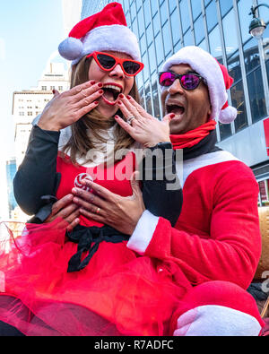 Revelers dressed in Santa Claus and other costumes participate in the ...