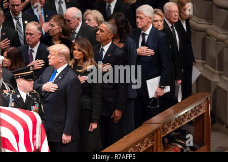 People watch former First Lady Michelle Obama speaking during the ...