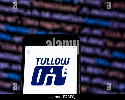 The Tullow Oil logo is seen on an LED screen in the background while a ...