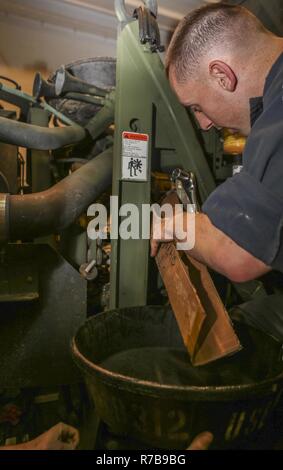 A U.S. Army Soldier operates a rough-terrain container handler to load ...
