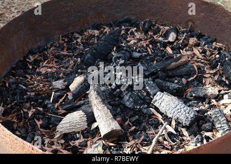 Remnants of burnt firewood at a campsite Stock Photo - Alamy