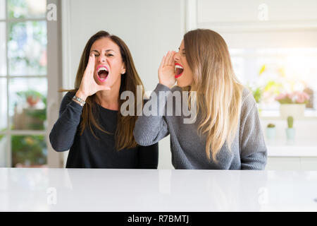 Hispanic mother and daughter together shouting and screaming loud to ...