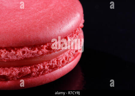 Bright juicy delicious macarons pink color on a black background.Banner ...