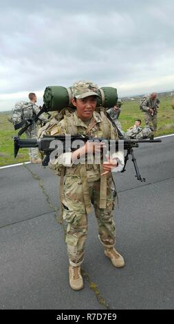 A female U.S. Army soldier carries test equipment away after inspecting ...