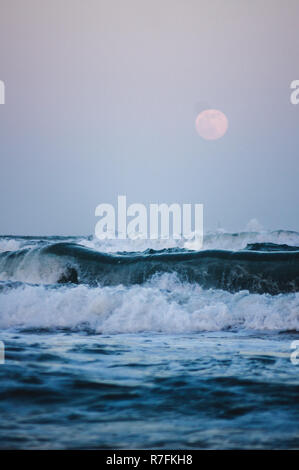 A hurricane with a black full moon Stock Photo - Alamy